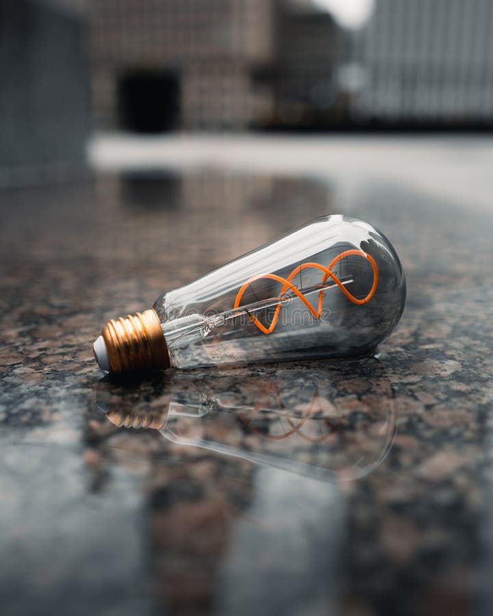 Vertical Shot of a Light Bulb Placed on a Marble Surface Stock Image ...
