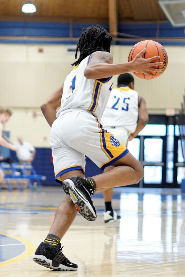 Vertical Shot of a Lighthouse Basketball Player Playing on a Field at a ...