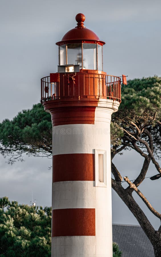 Vertical Shot of a Lighthouse with the Cloudy Skies in the Background ...