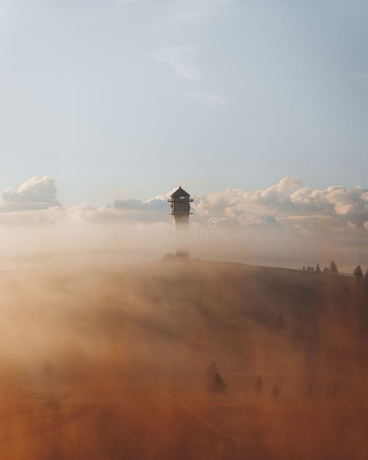 Vertical Shot of a Lighthouse Covered by Fog Stock Image - Image of ...