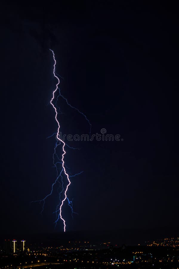 Vertical Shot of Lightning Above a City at Night - Great for Wallpapers ...