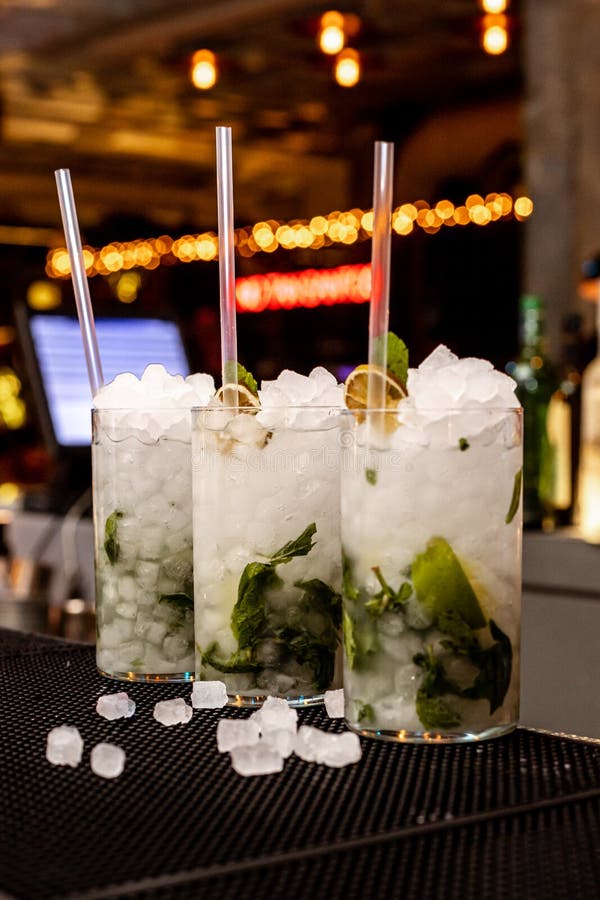 Vertical Shot of Lime Cocktaila on a Bar Stock Photo - Image of mint ...