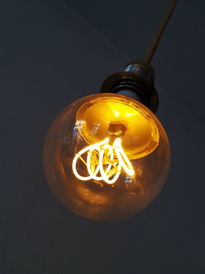 Vertical Shot of a Lit Light Bulb Hanging from the Ceiling Stock Photo ...
