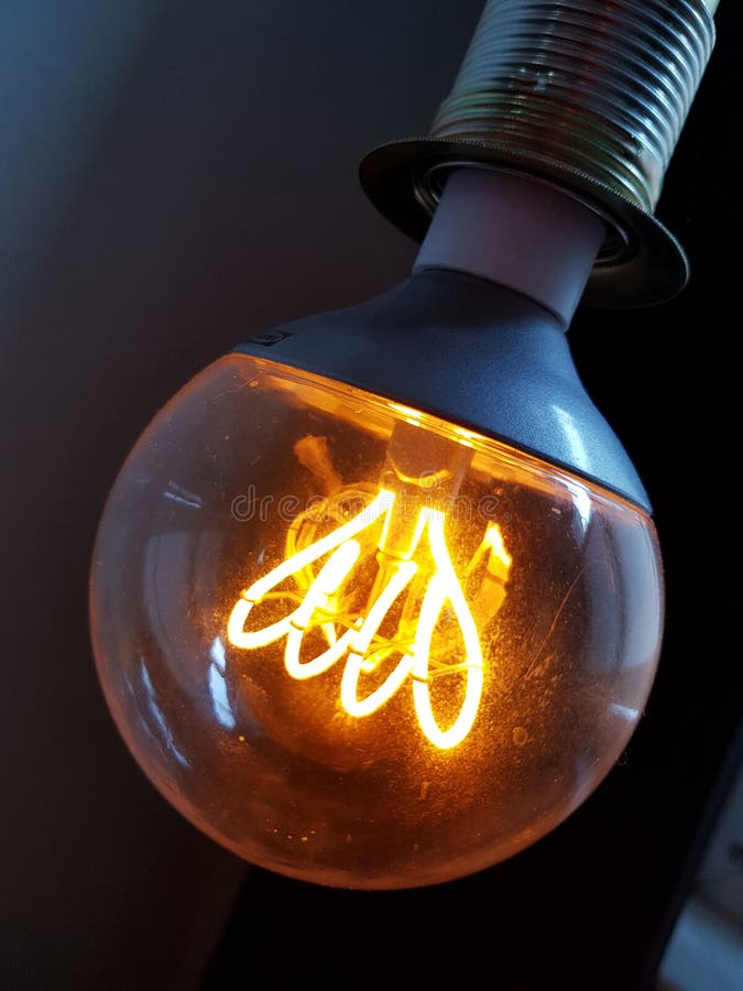 Vertical Shot of a Lit Light Bulb Hanging from the Ceiling Stock Image ...
