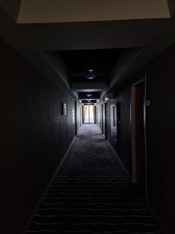 A Dark Hallway with Graffiti Walls and Concrete Flooring in a Dark ...