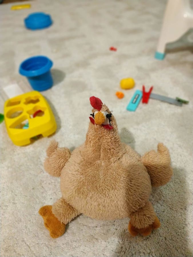 Vertical Shot of a Lovely Hen Toy Sitting on the Ground Stock Image ...