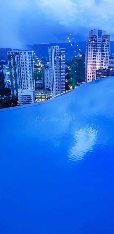 Vertical Shot of Luxury Rooftop with Infinity Pool and Cebu City in the ...