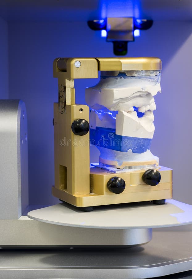 Vertical Shot of a Machine with Sculpted Jaws and Teeth and Blue Light ...