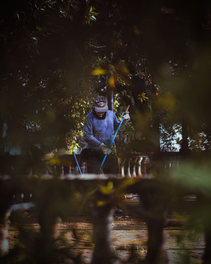 Vertical Shot of a Male Brooming in the Park Stock Image - Image of ...