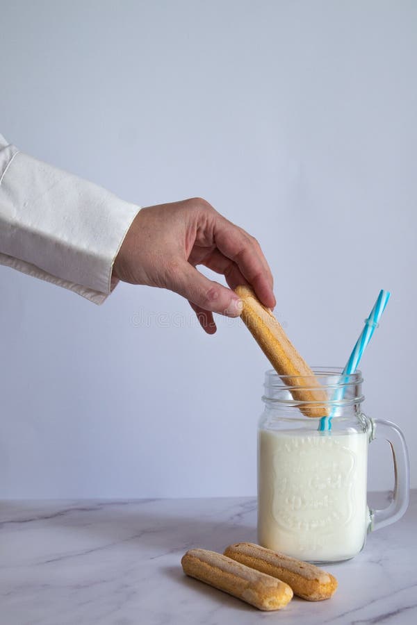 Vertical Shot of Male Hand Dipping Cookie on a Milkshake Stock Image ...