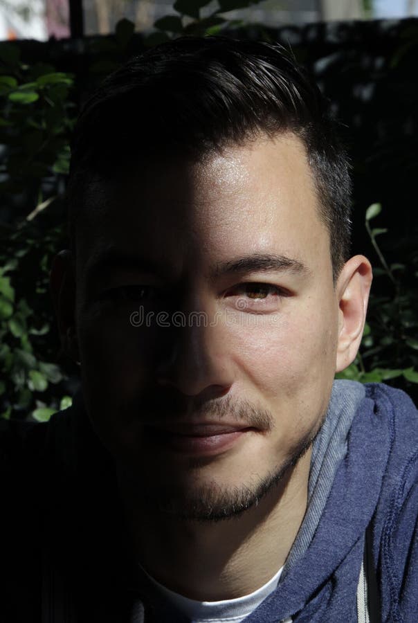 Vertical Shot of a Man Having Half of His Face Covered in Shadow Stock ...