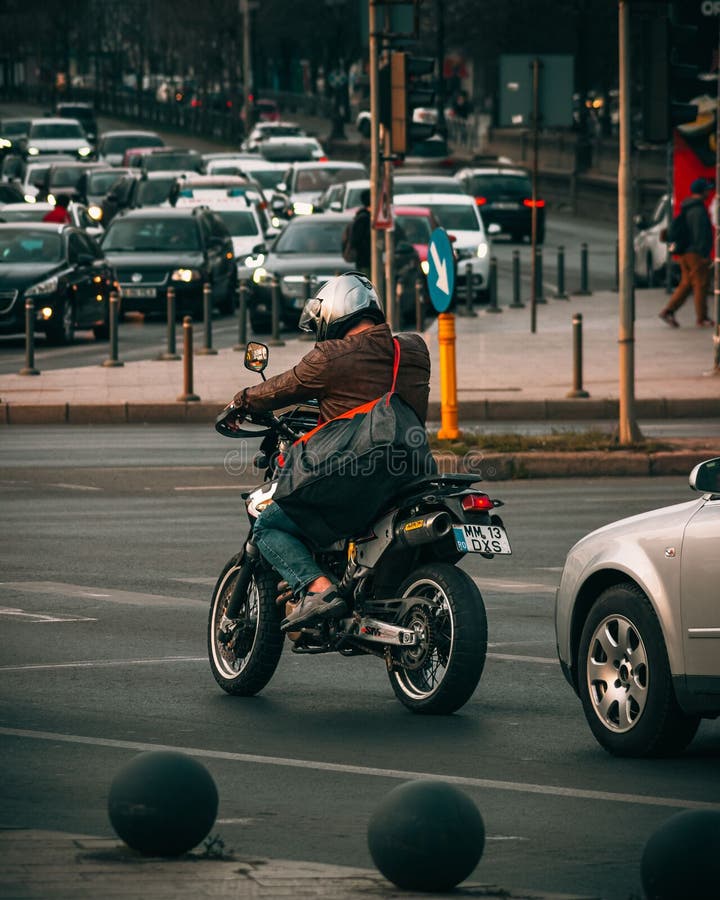 Vertical Shot of a Man on a Motorcycle at a Red Traffic Light at Piata ...