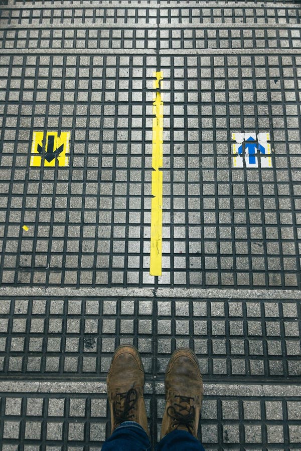 Vertical Shot of Man S Feet on a Pavement with Small Arrows Stock Photo ...