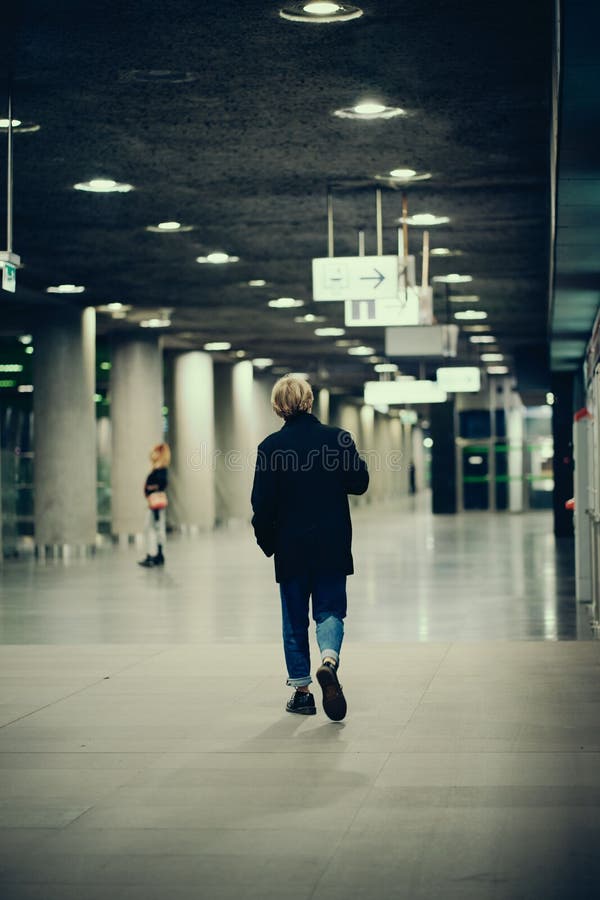 Vertical Shot of a Man Walking at an Empty Station Stock Photo - Image ...