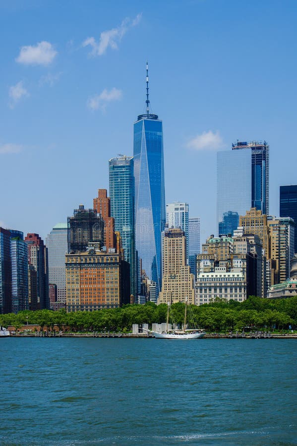 Vertical Shot of the Manhattan View from a Ferry with a Blue Skyscape ...