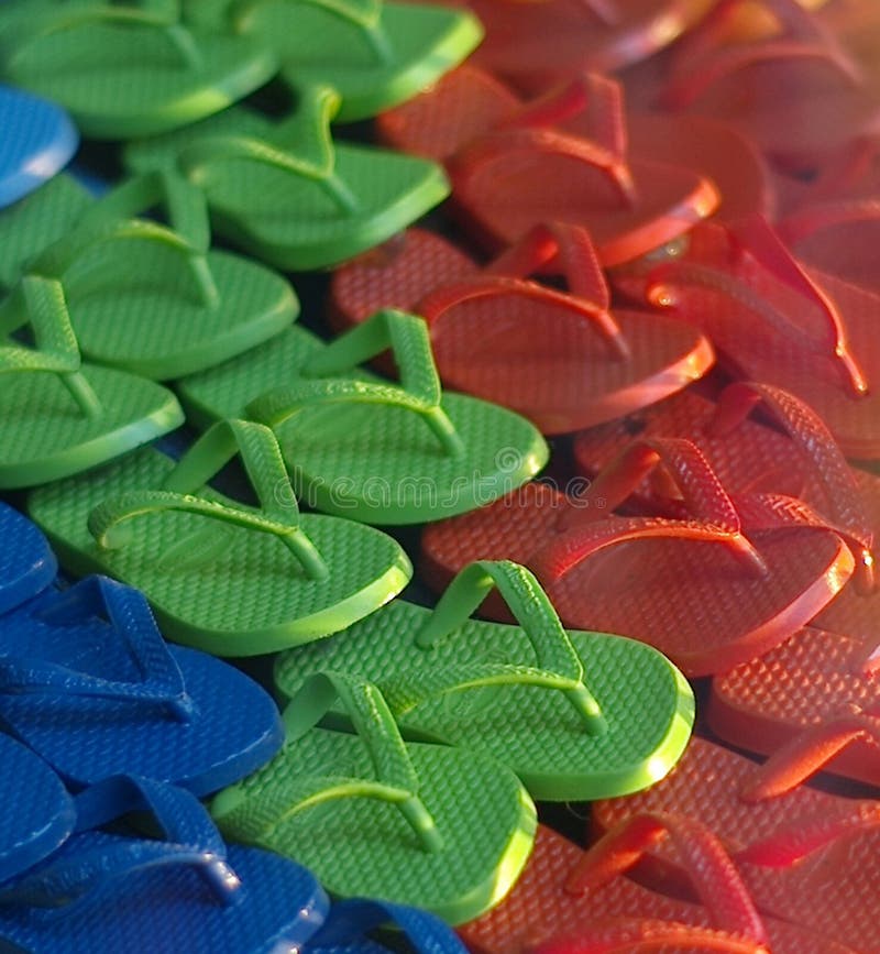Vertical Shot of Many Blue, Green, and Red Rubber Slippers Stock Image ...