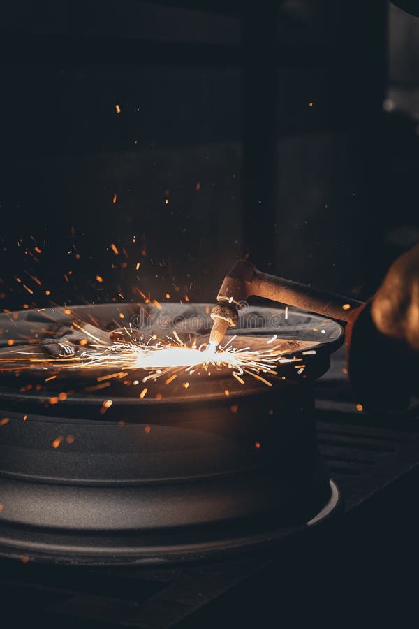 Vertical Shot of a Master Welding and Cutting a Car Disk Wheel Stock ...