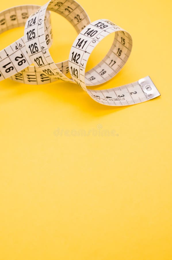 Vertical Shot of a Measuring Tape Isolated on Yellow Background Stock ...