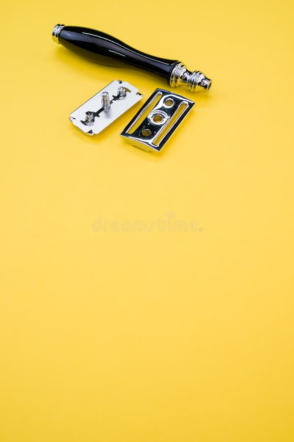 Vertical Shot of a Mechanical Razor and Blade Isolated on Yellow ...