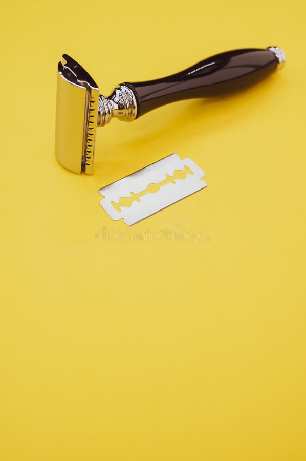 Vertical Shot of a Mechanical Razor and Blade Isolated on Yellow ...