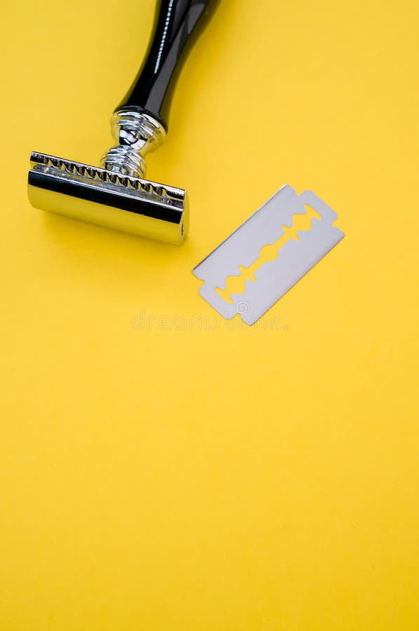 Vertical Shot of a Mechanical Razor and Blade Isolated on Yellow ...