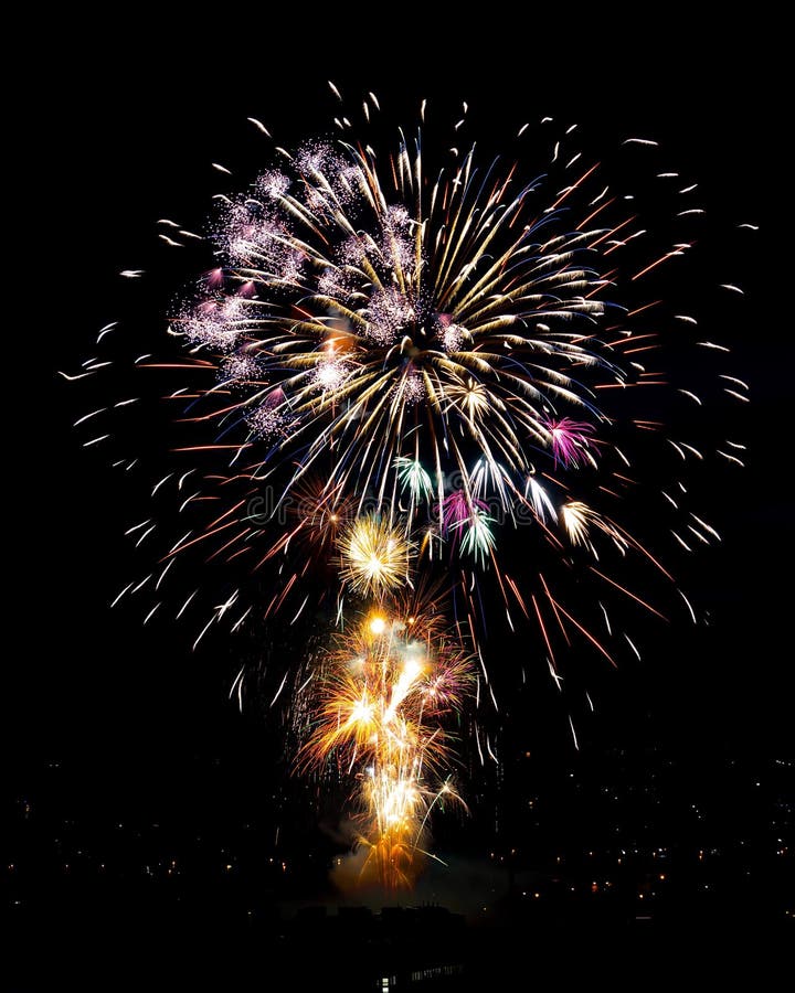 Vertical Shot of the Mesmerizing Exploding Fireworks in the Night Sky ... Vertical Shot of the Mesmerizing Exploding Fireworks in the Night Sky ...