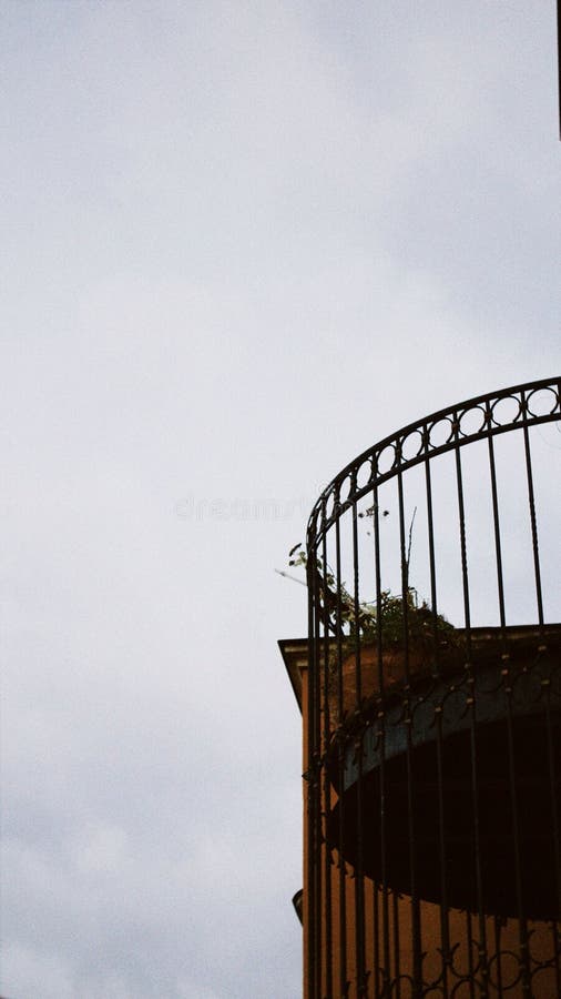 Vertical Shot of a Metal Balcony Railing Against the Background of the ...