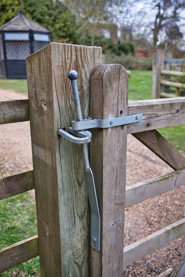 Vertical Shot of a Metal Lock on a Wooden Gate Stock Photo - Image of ...