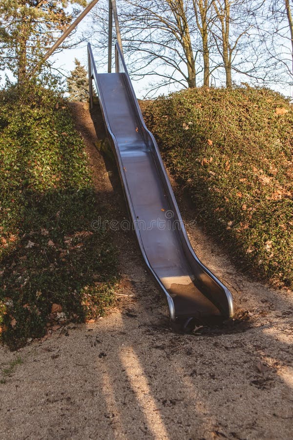 Vertical Shot of a Metal Slide in a Playground Stock Photo - Image of ...