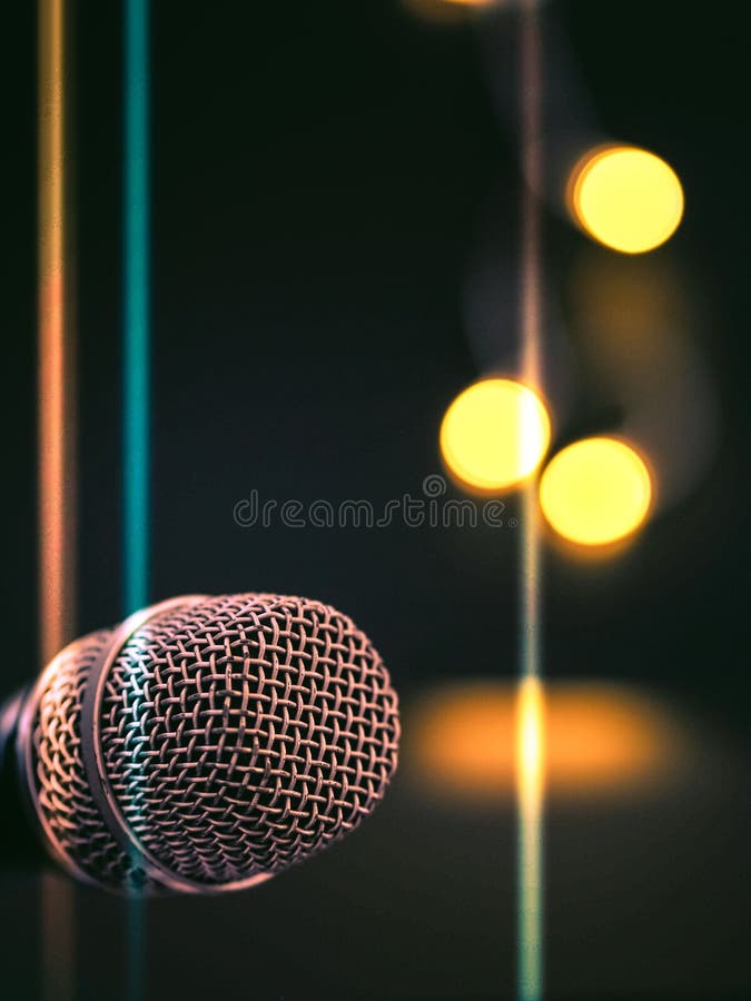 Vertical Shot of a Microphone with Bokeh Lights in the Background Stock ...