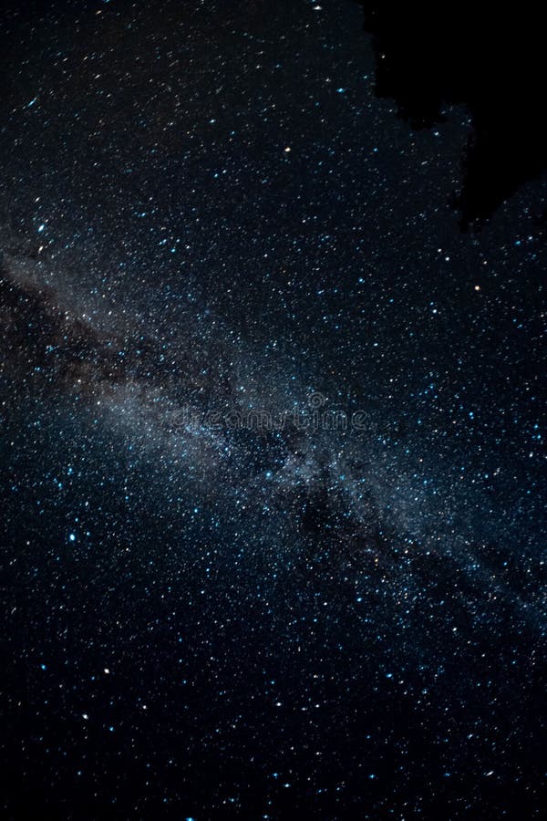 Vertical Shot of Milky Way Illuminating a Dark Night Sky Stock Photo ...