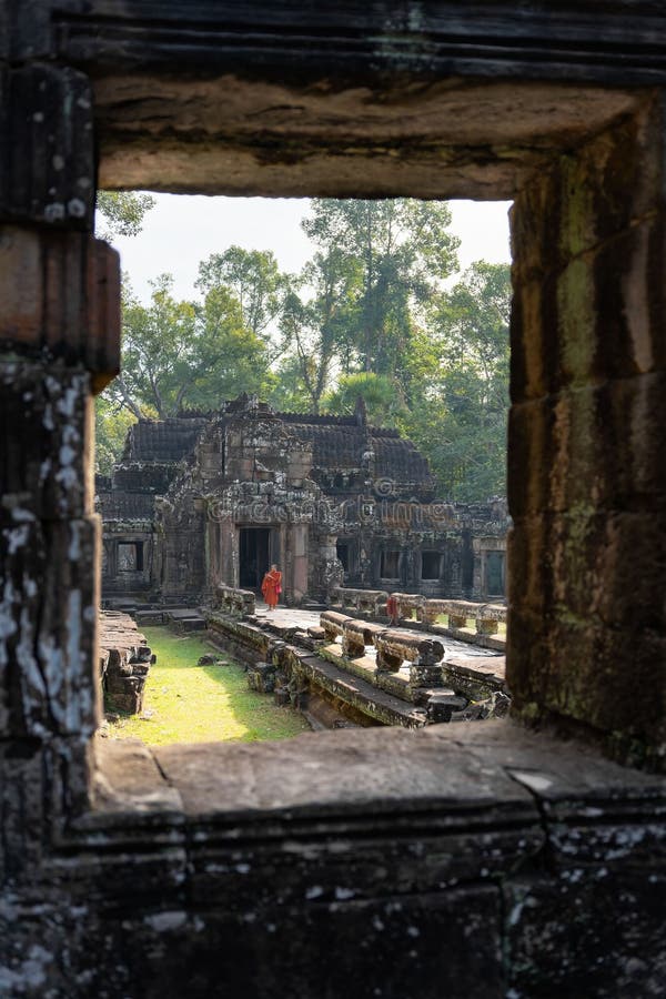 Vertical Shot of a Monk Standing among the Ruins of a Temple, Seen ...