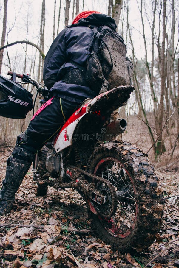 Vertical Shot of a Motorcyclist Getting Ready for a Ride in a Forest ...