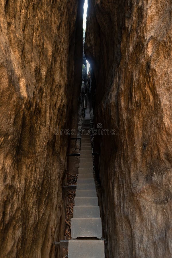 Vertical Shot of Narrow Stairs between Two Large Stones in a Cave Stock ...