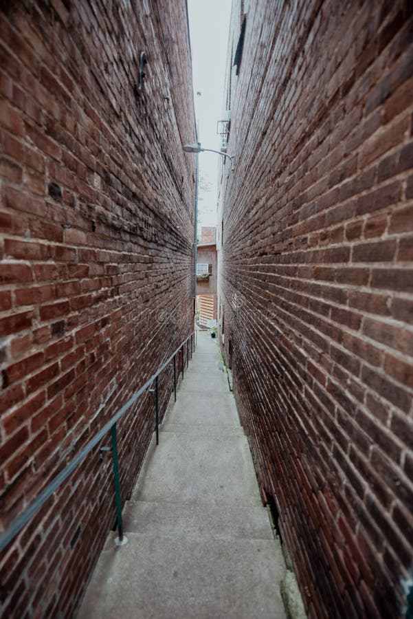 Vertical Shot of a Narrow Stairway between Brick Walls. Stock Image ...