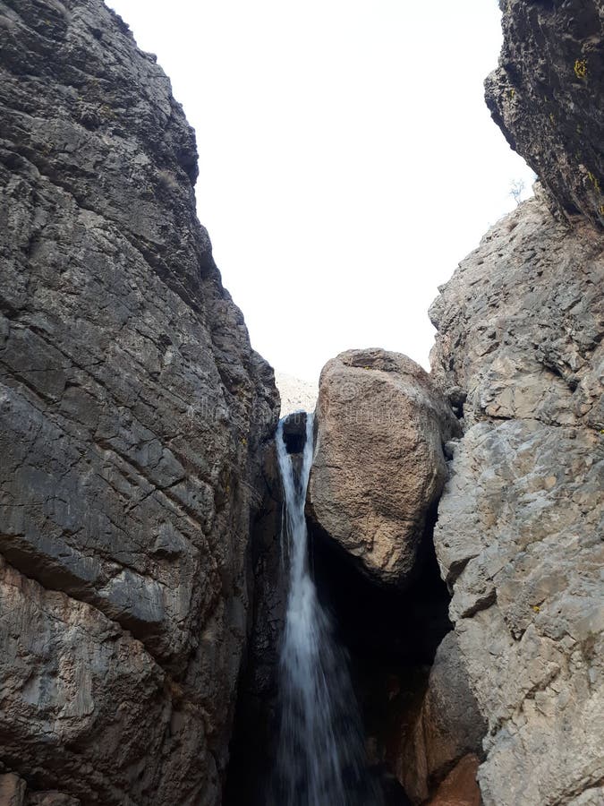 Vertical Shot of a Narrow Waterfall in the Cliffs Stock Image - Image ...