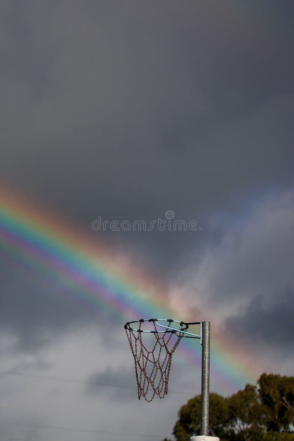 Vertical Shot of a Netball Ring Against Rainbow in the Sky Stock Photo ...