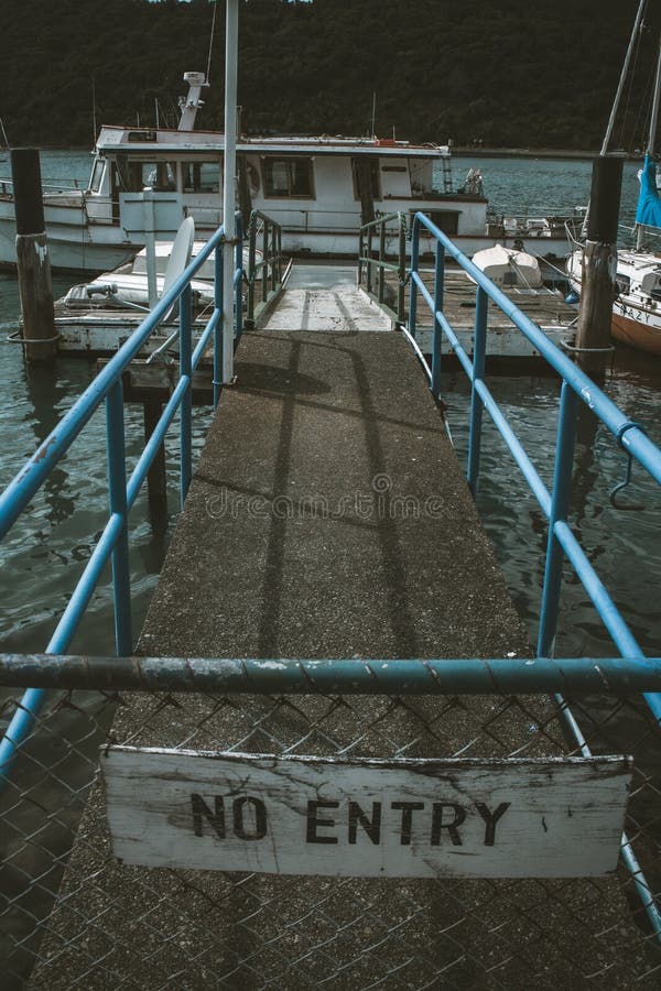 Vertical Shot of NO ENTRY Sign on the Dock with Blue Railings Stock ...