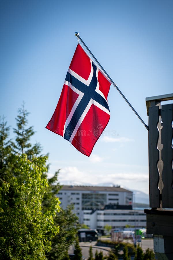 Vertical Shot of the Norwegian Flag Hanging from a Balcony with ...