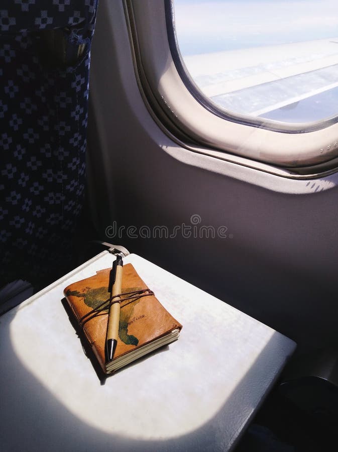 Vertical Shot of a Notebook Captured Inside an Airplane Stock Image ...
