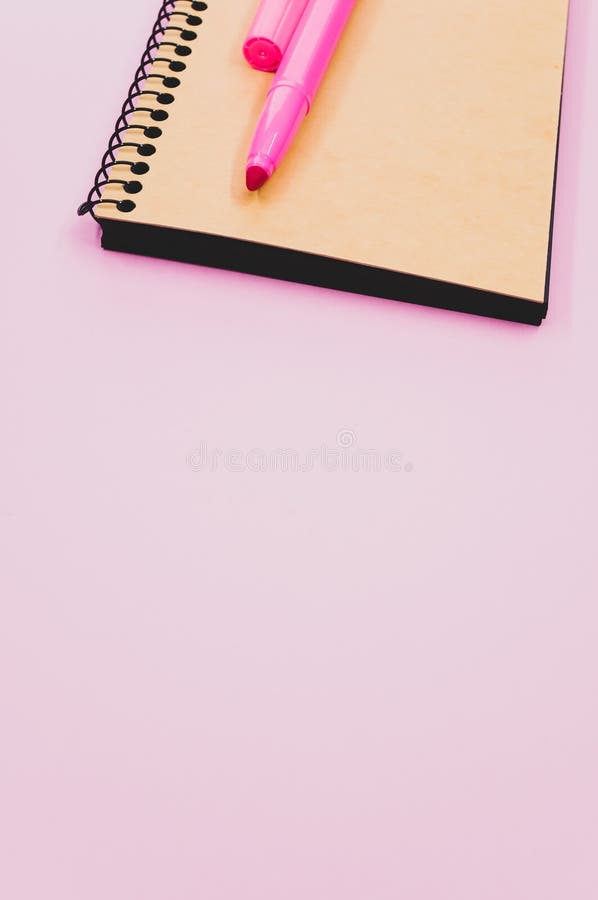 Vertical Shot of a Notebook and a Pink Marker on a Pink Surface Stock ...