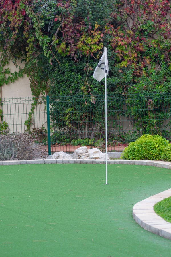 Vertical Shot of a Number 5 Flag Over a Putt Hole on a Minigolf Course ...