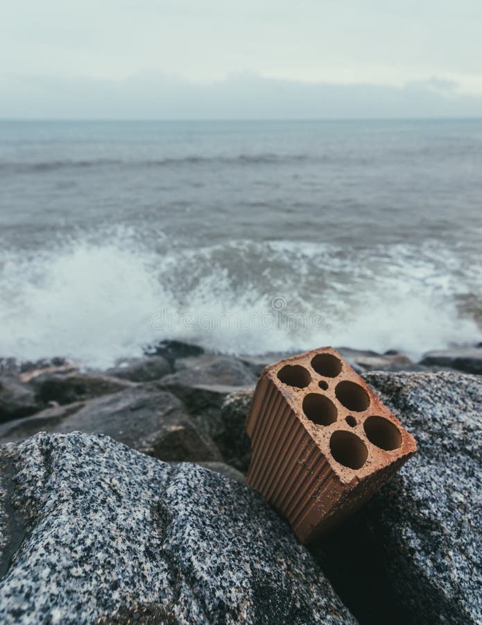 Vertical Shot of an Old Brick on the Rocks on the Beach by the ...