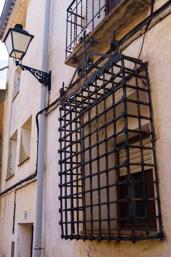 Vertical Shot of an Old Building with Metal Window Gates Stock Image ...