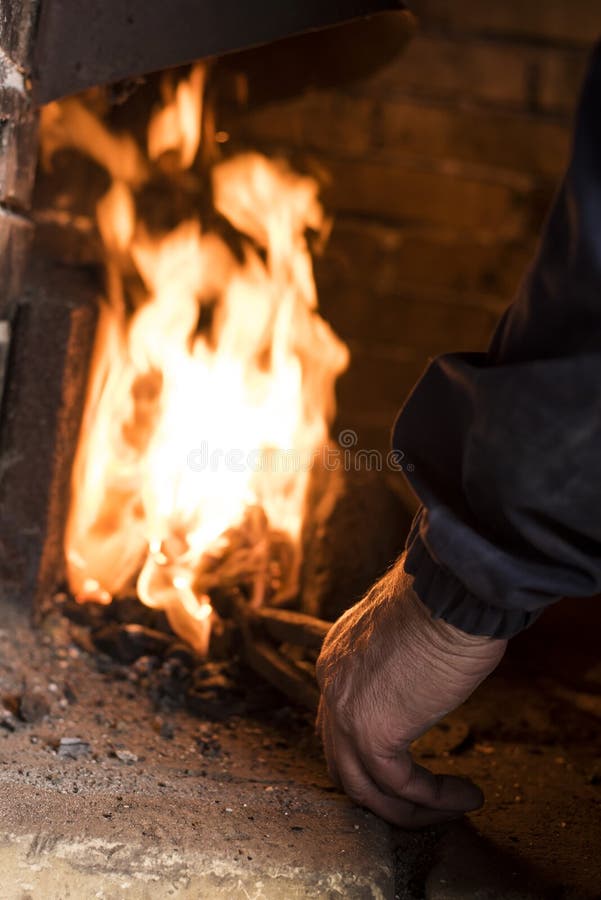 Vertical Shot of an Old Hand Holding a Branch with Fire Stock Image ...