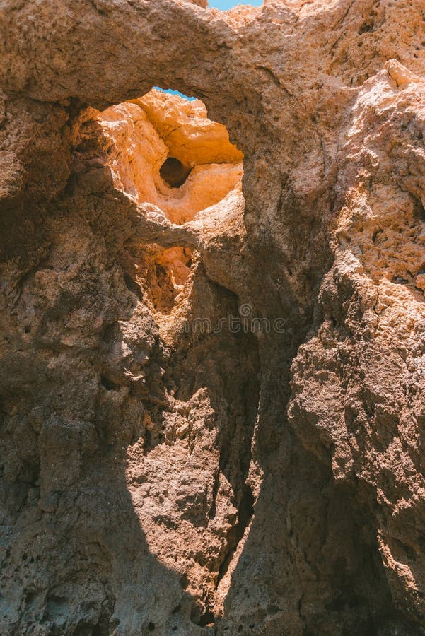 Vertical Shot of an Old Rock Formation with Holes Stock Photo - Image ...