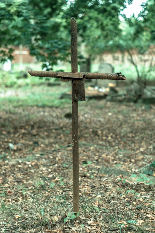 Vertical Shot of an Old Rusted Cross with a Spider Web on it in the ...