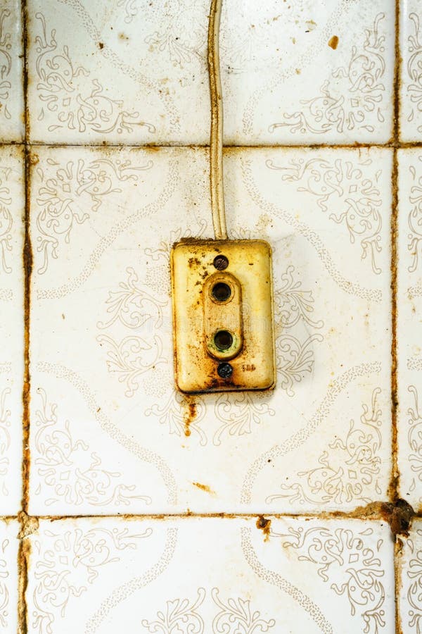 Vertical Shot of an Old Rusty Socket on a Dirty Ceramic Wall Stock ...