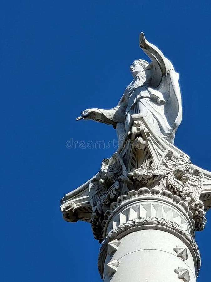 A Vertical Shot of an Old Statue Under a Blue Sky Editorial Photography ...