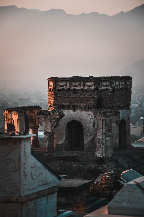 Vertical Shot of Old Structure Ruins Near Mountains in Fog Stock Image ...
